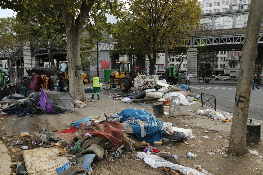Paris police dismantle tent camp where 2,100 migrants were living in squalid conditions | Public ...